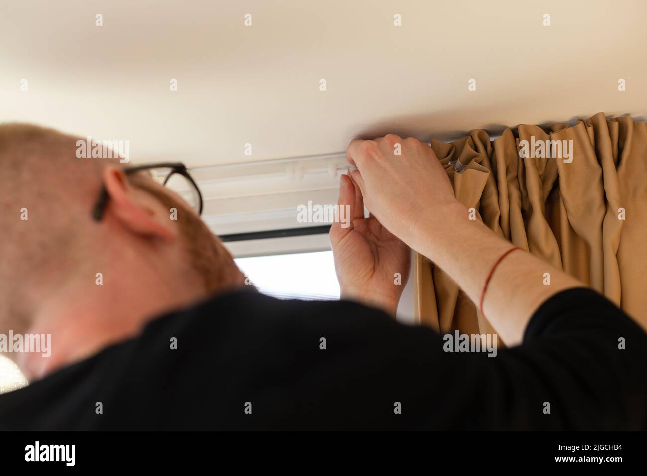 Man hanging off ledge hi-res stock photography and images - Alamy