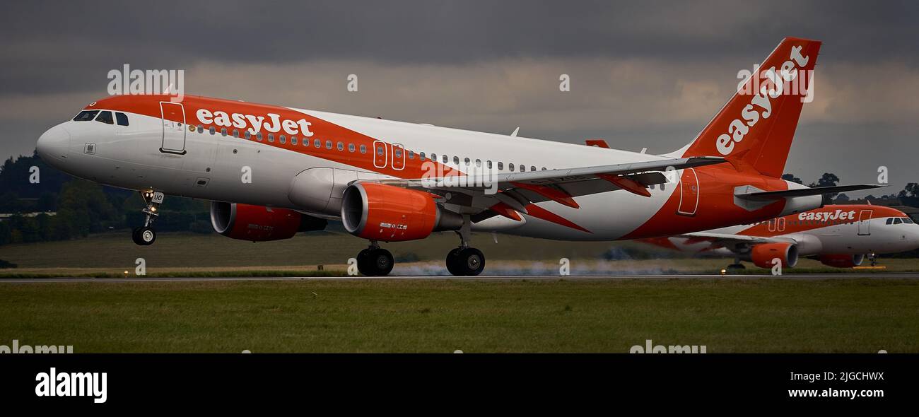 A panoramic shot of an Easyjet plane on a runway preparing to take off ...
