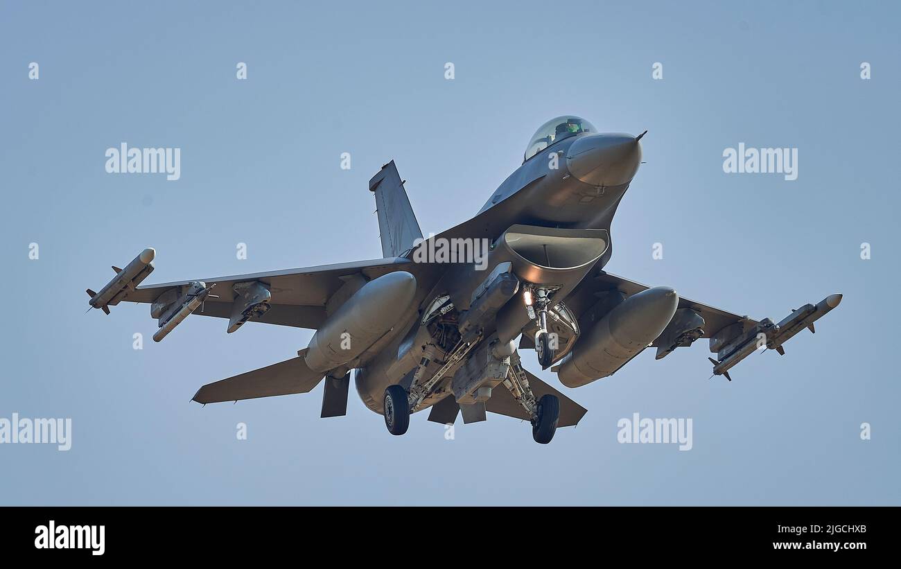 A low-angle shot of the F-16 Fighting Falcon in flight approaching the ...
