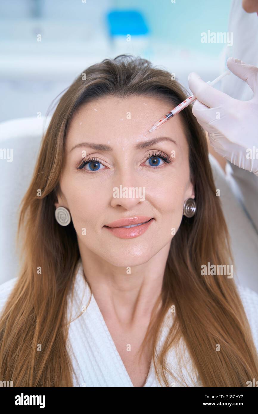 Patient Undergoing Forehead Skin Rejuvenation Procedure With Injections
