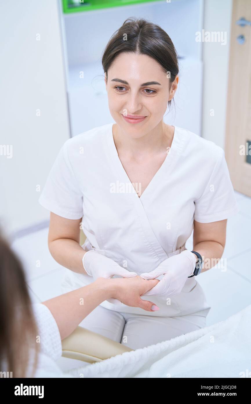 Doctor doing hand massage to a patient Stock Photo - Alamy