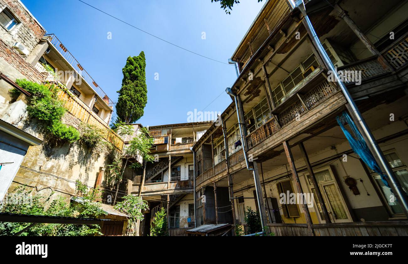 Traditional Tbilisi's inner yard with wooden carving balconies in the ...