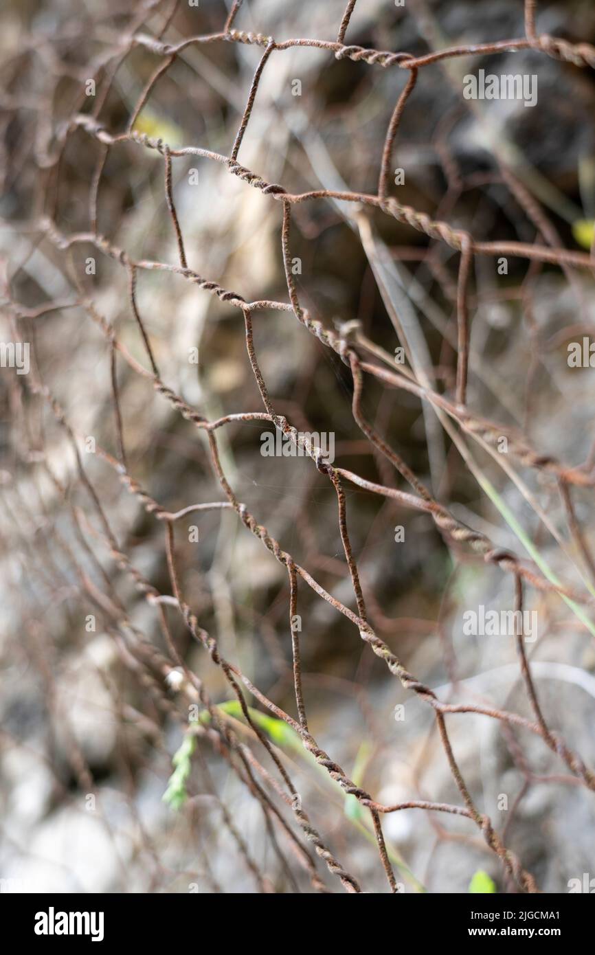 A protective metal mesh covers the rocks from rockfall. Metallic net ...
