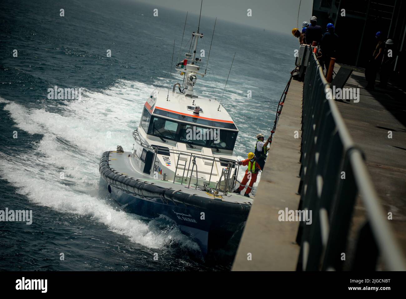 220613-A-EQ028-1004 ARABIAN GULF (June 13, 2022) A tug boat pulls ...