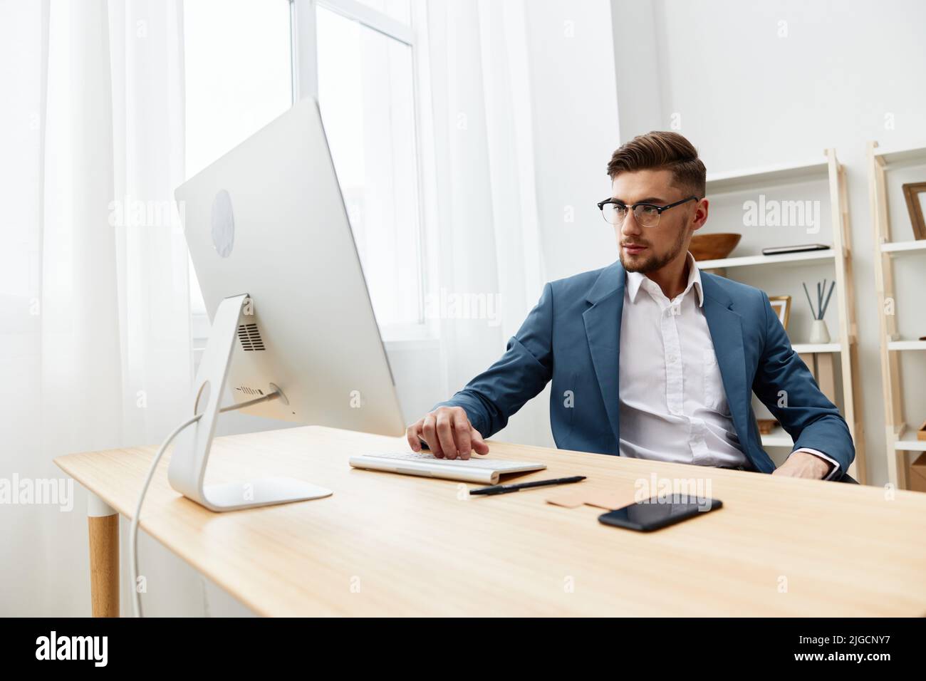 a man in a suit at the desk in the office an official executive Stock ...