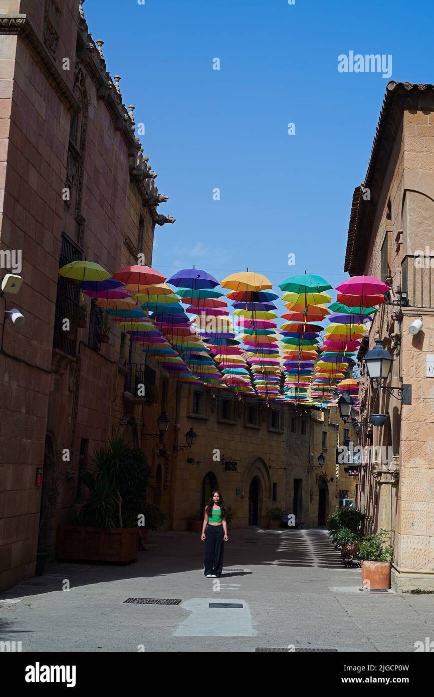 Beautiful coluorful umbrellas hanging across a typical street in the ...