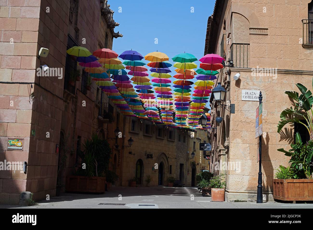 Beautiful coluorful umbrellas hanging across a typical street in the ...