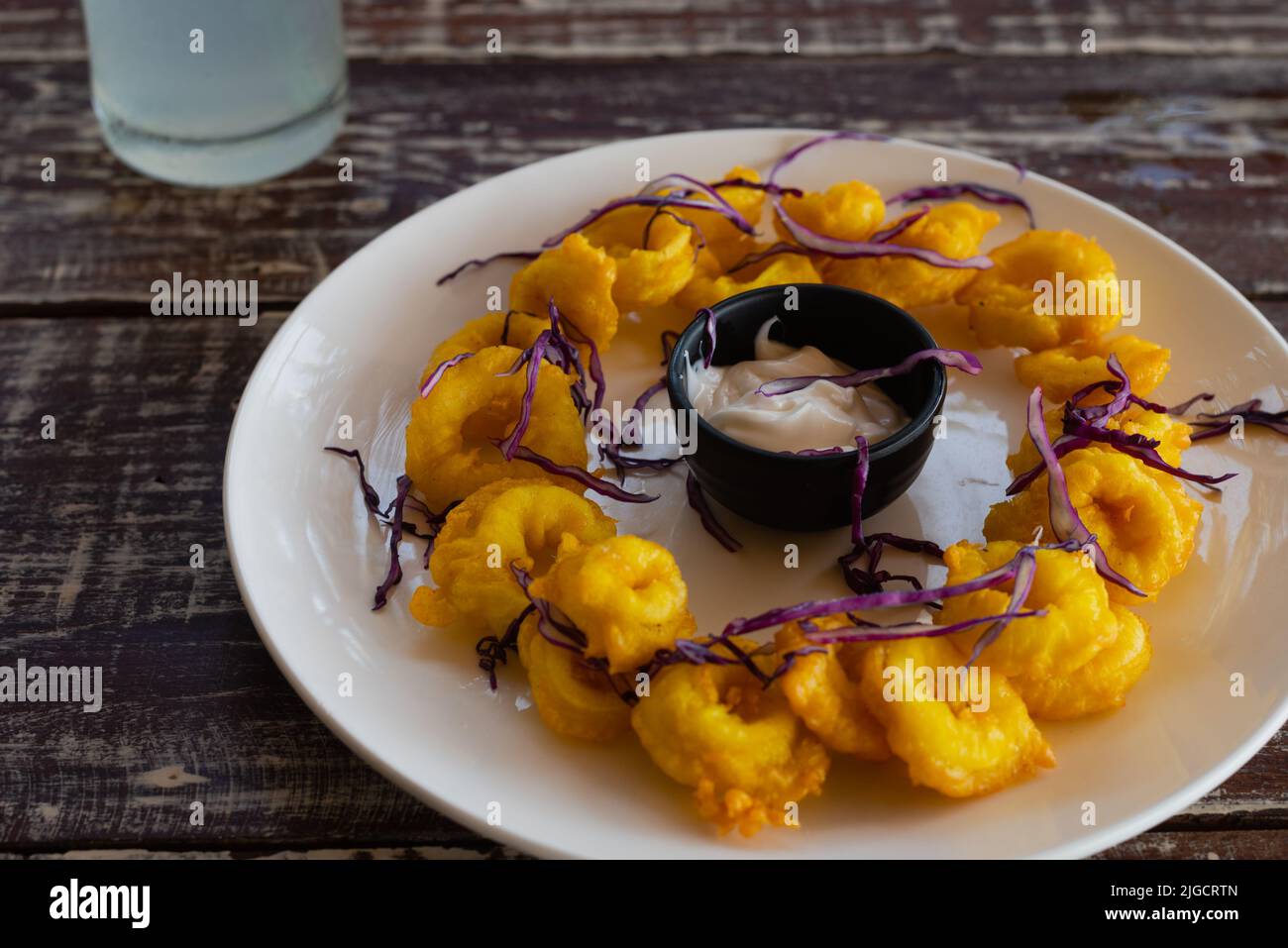 Delicious seafood meal of deep-fried golden squid rings on an platter ...