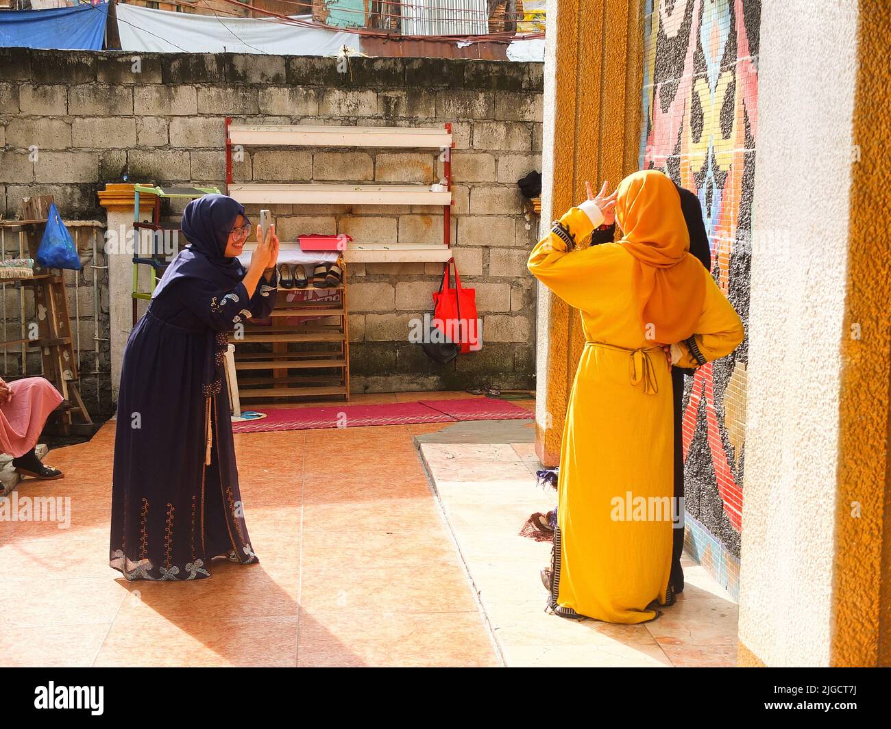 Muslim girls takes pictures at the Golden Mosque. The Muslim community ...