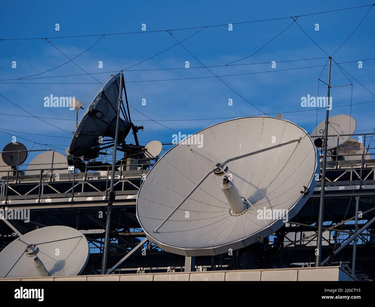 Satellite dishes against the background of blue sky Stock Photo - Alamy