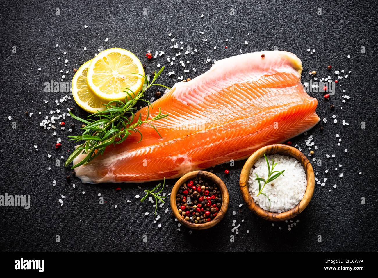 Fresh salmon fish at black top view Stock Photo - Alamy