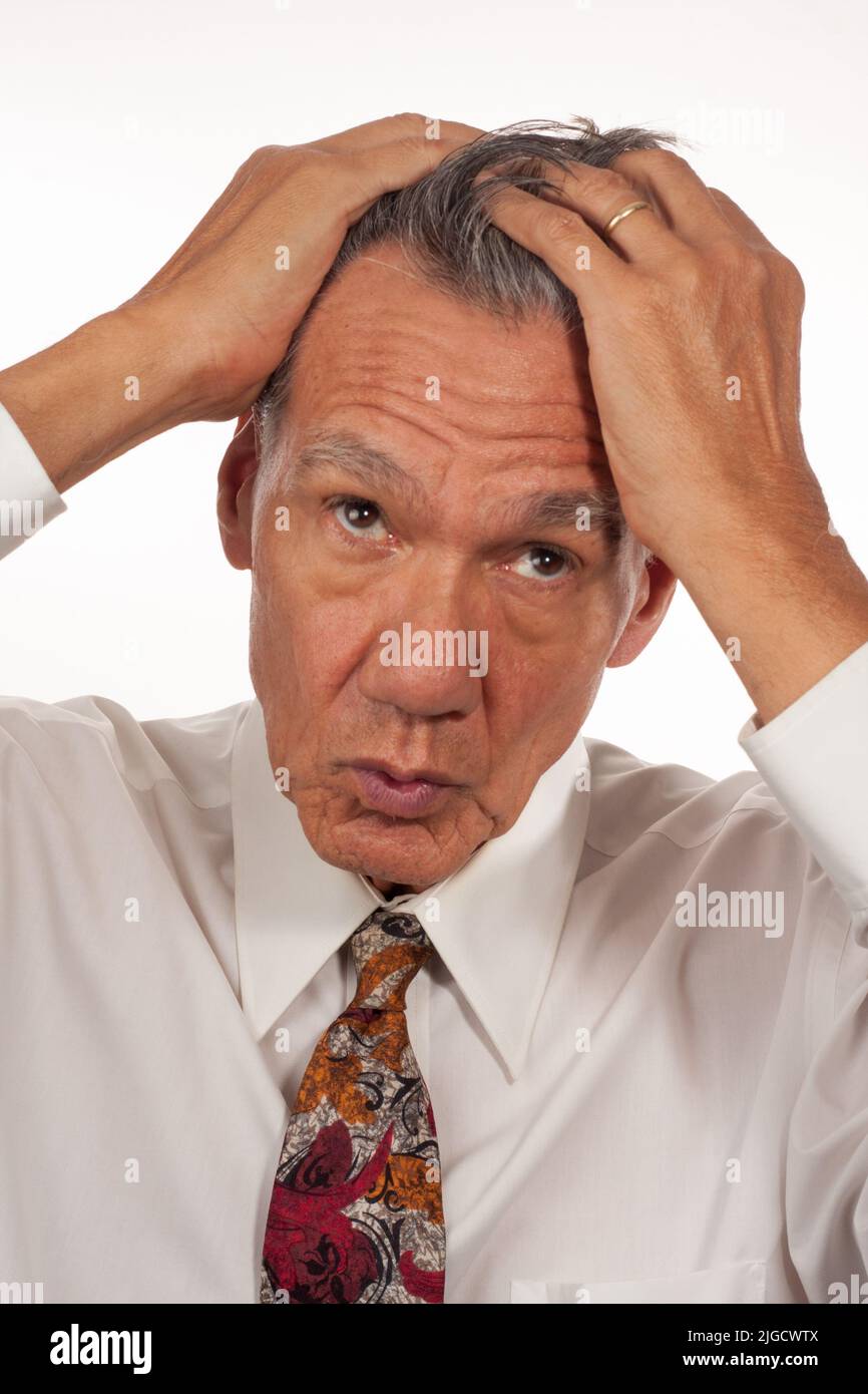 Mature man 60 plus running his hands through his hair Stock Photo - Alamy
