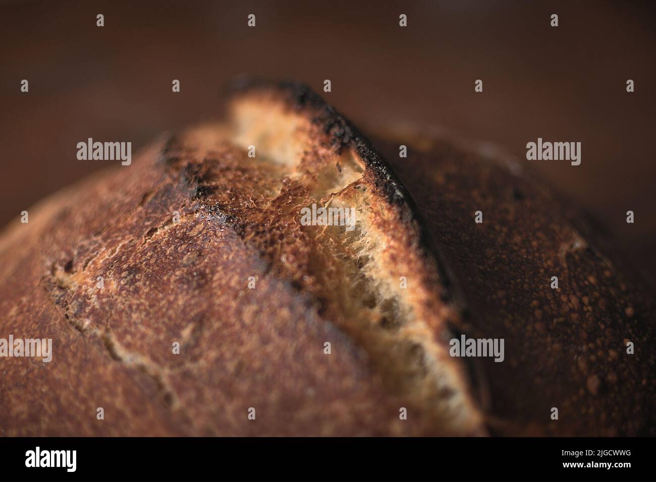 Perfect sourdough bread over a wooden table right out of the oven Stock ...