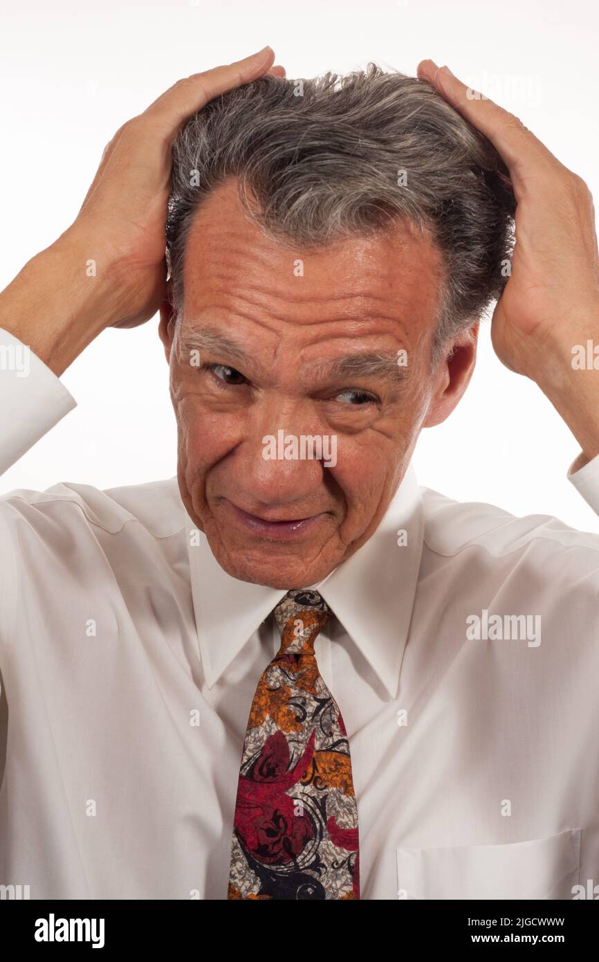 Mature man 60 plus running his hands through his hair Stock Photo - Alamy