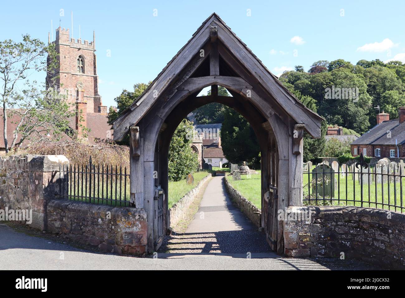 The lych gate of St George priory church in Dunster, Somerset. It marks ...