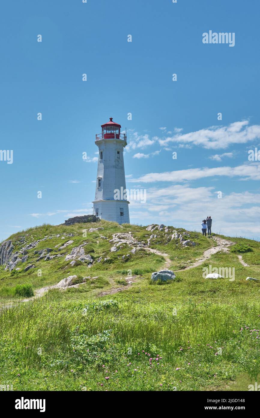 Visitors seen photographing the historic Louisbourg Lighthouse on Cape ...