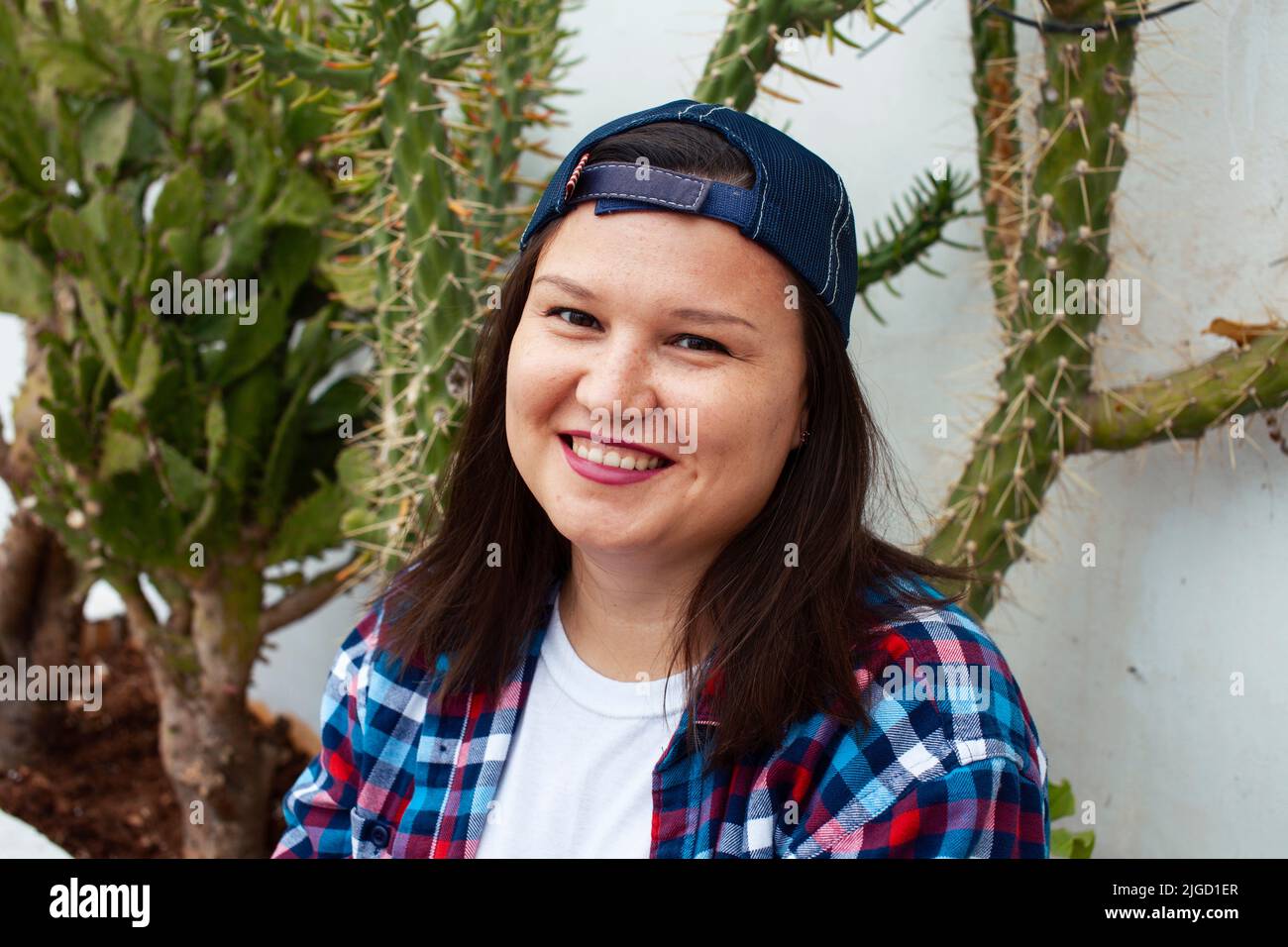 yound pretty american woman siting smiling among cactuses, lifestyle ...