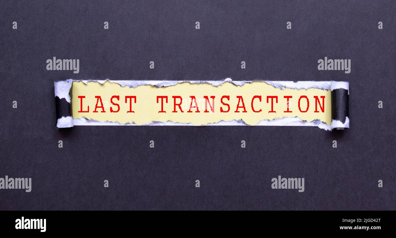 Closeup on businessman holding a card with text LAST TRANSACTION ...