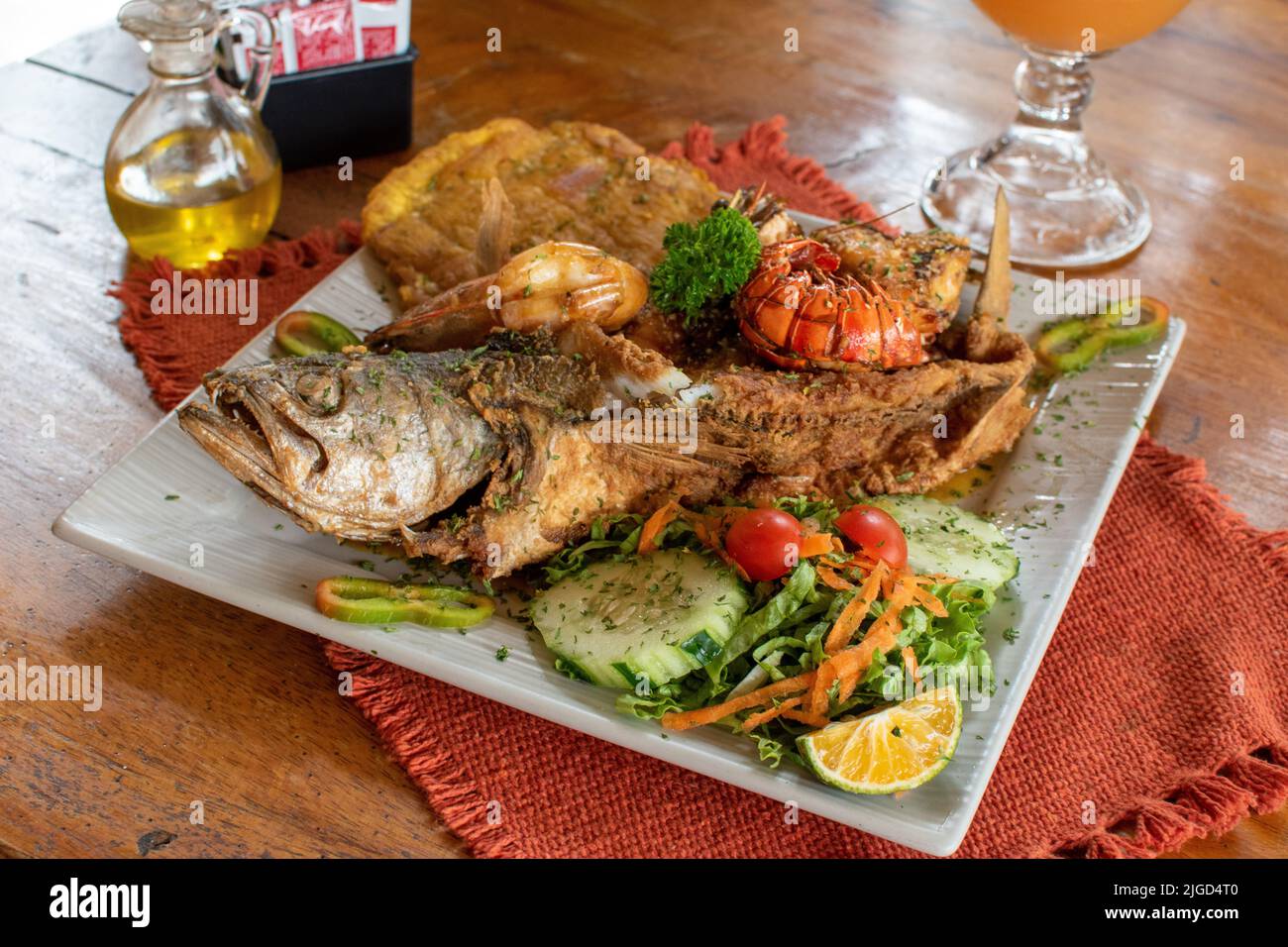 Whole fried fish with salad and fried plantain horizontal Stock Photo ...