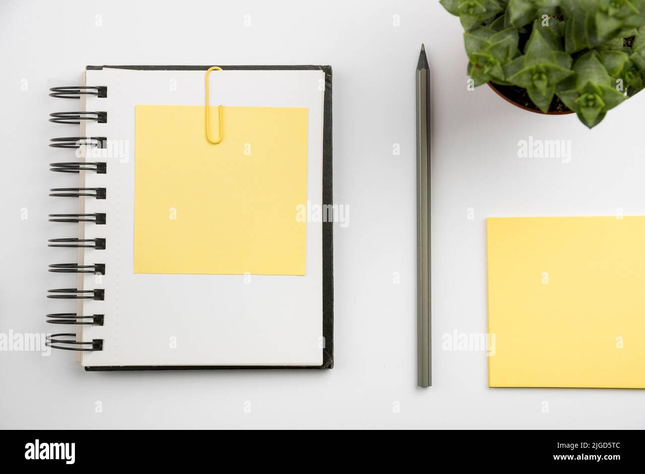A top view of a notebook and yellow sticky notes with copy space on a ...