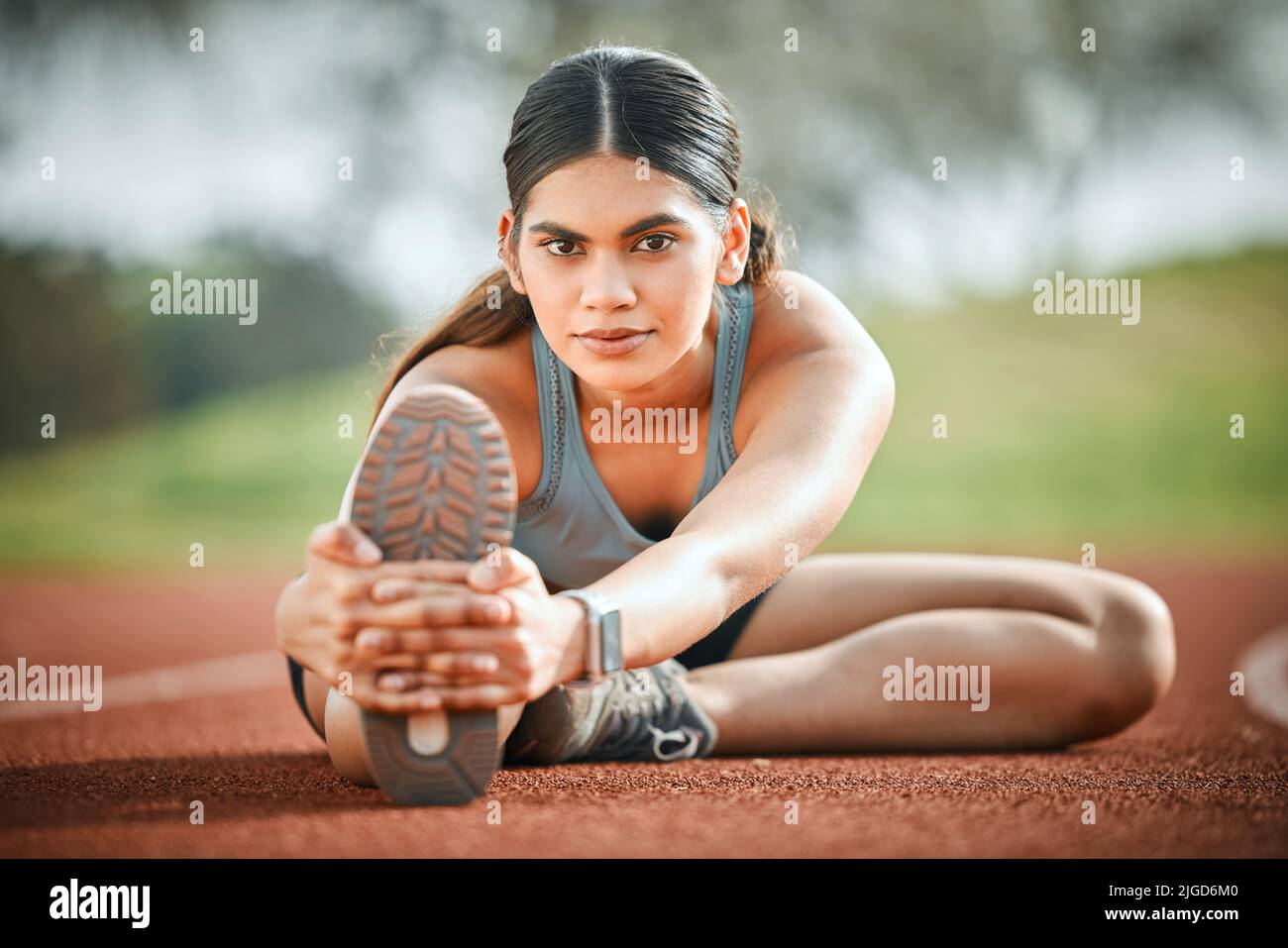 Doing all her stretches for better performance. Portrait of a young ...