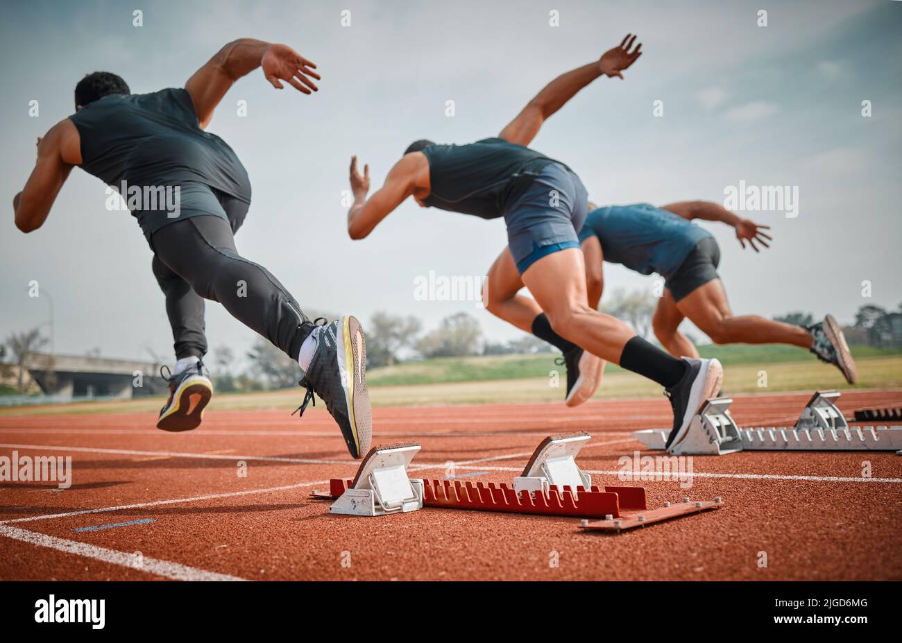 And theyre off. Rearview shot of three unrecognizable young male ...
