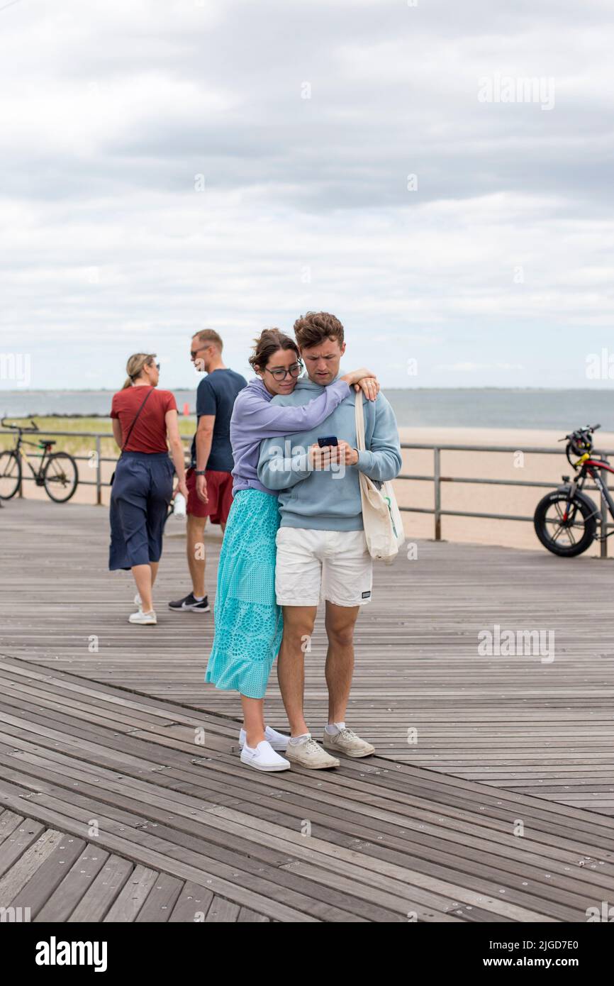 Two couples on the Coney Island promenade Stock Photo - Alamy