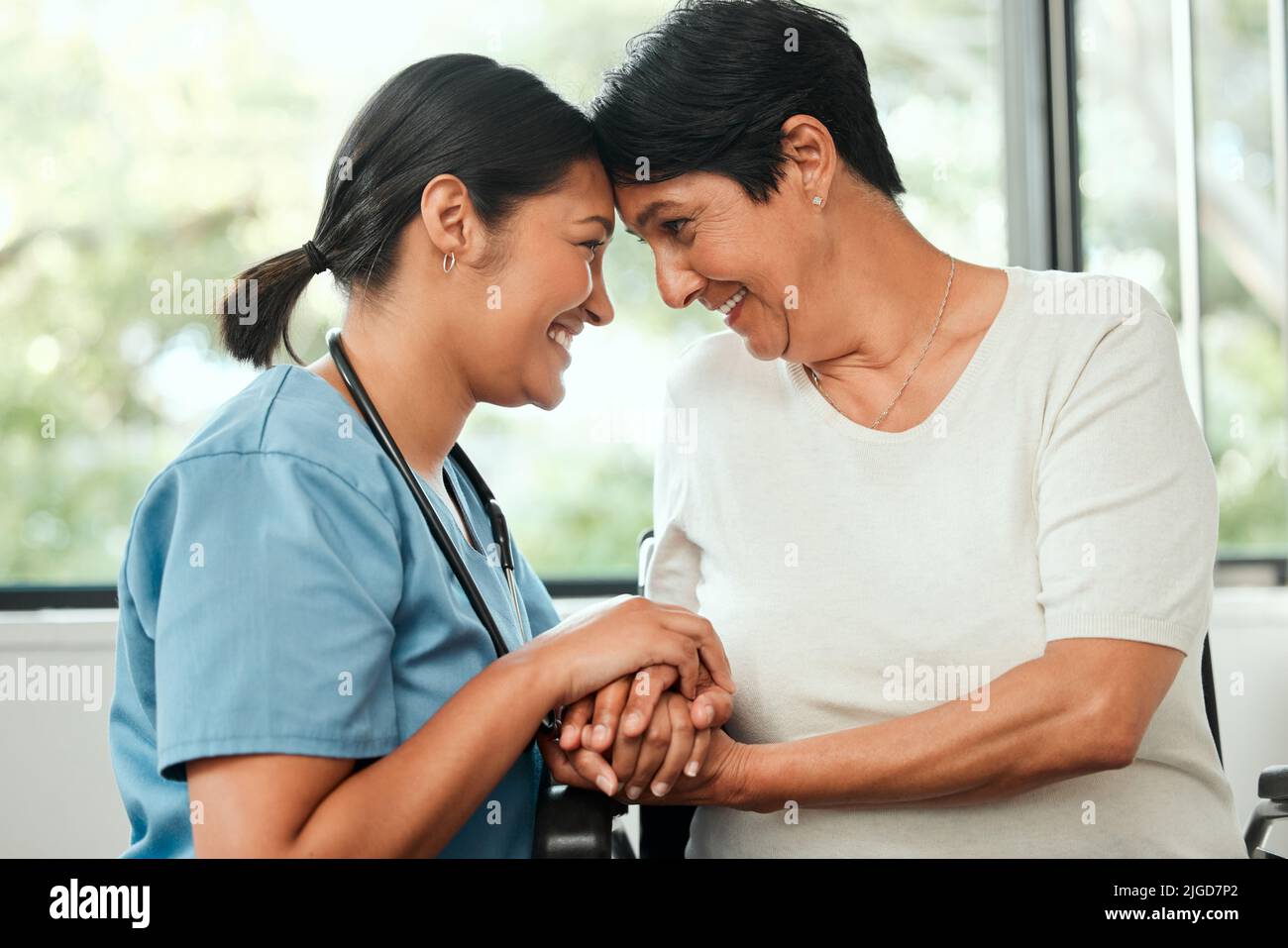 People deserve a loving carer. a young nurse caring for an older woman ...