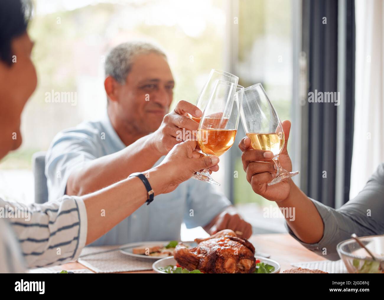Cheers to family. a family toasting with wine glasses at home Stock ...