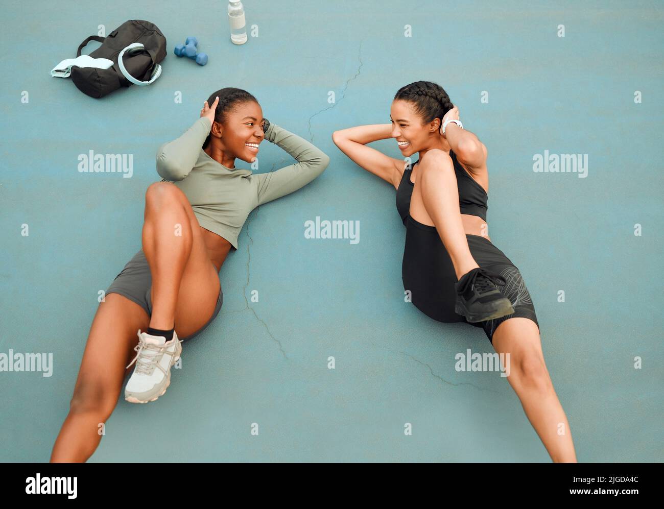 Lets go. High angle shot of two attractive young female athletes doing ...