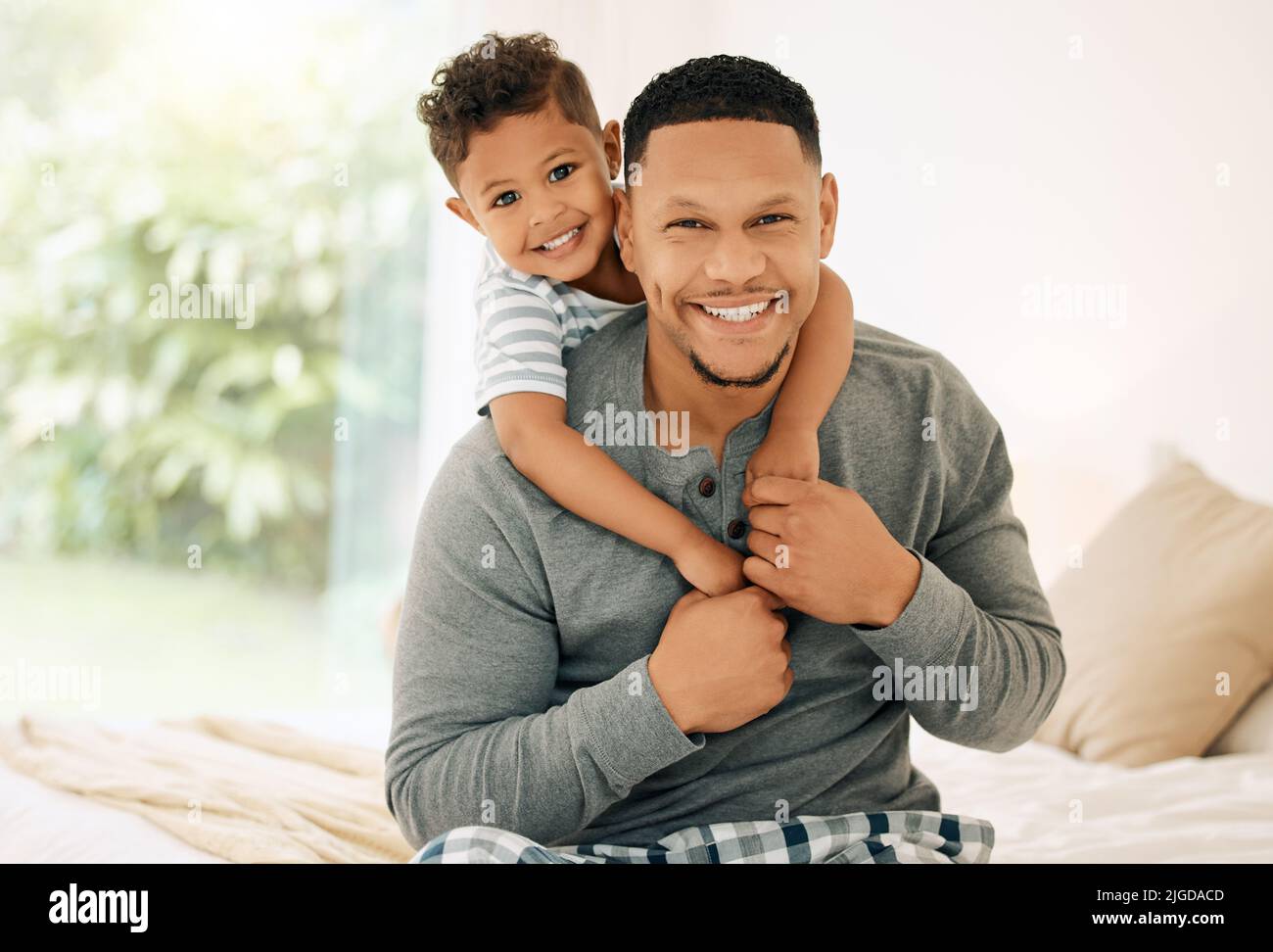 Extra hugs to get dad through the day. Portrait of a young father and ...