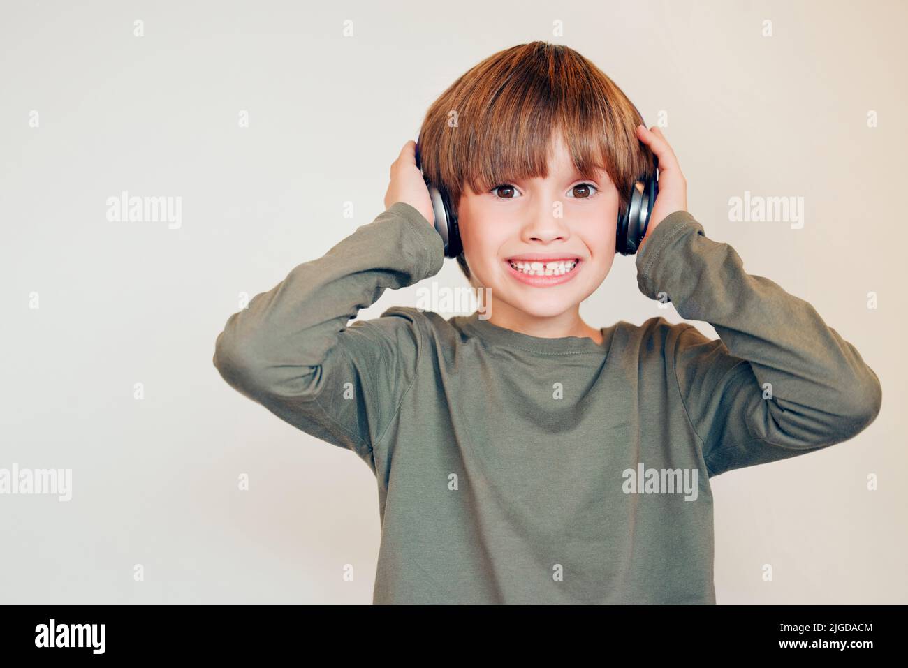 This is my favourite song. Studio shot of a cute little boy using ...