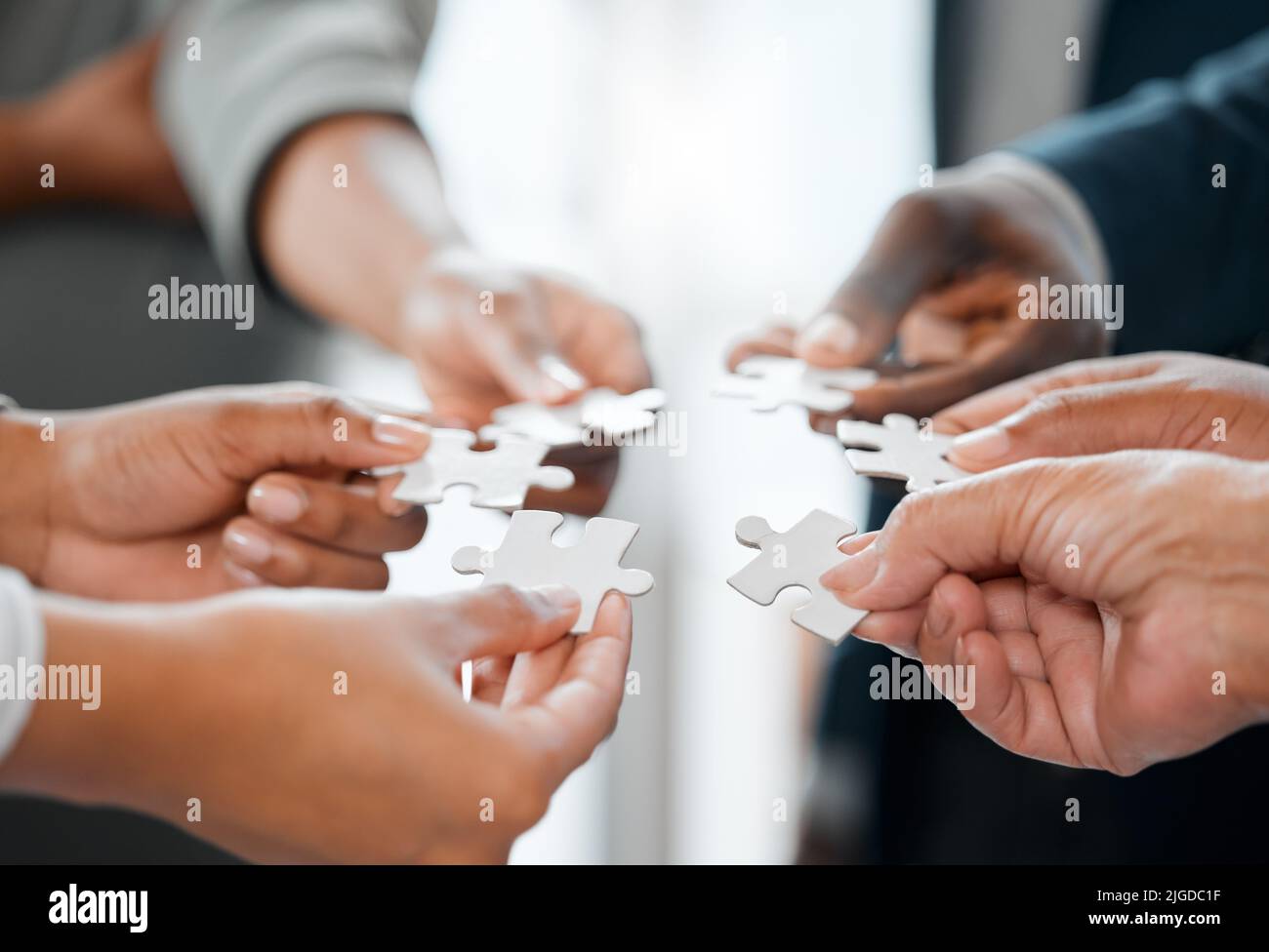 Piecing it all together. a group of unrecognizable businesspeople ...