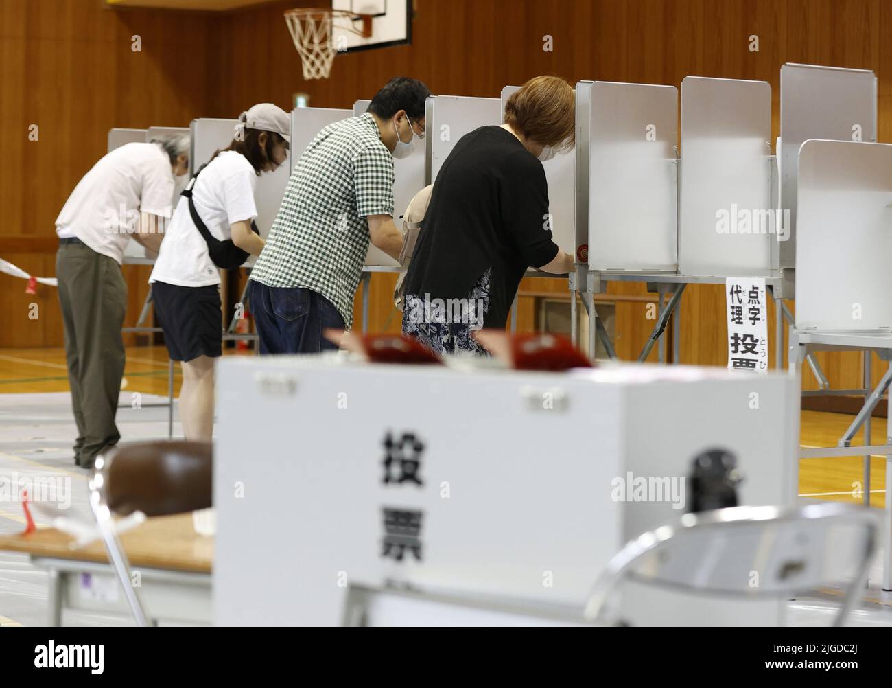 Voters fill out their ballots for Japan's House of Councillors election ...