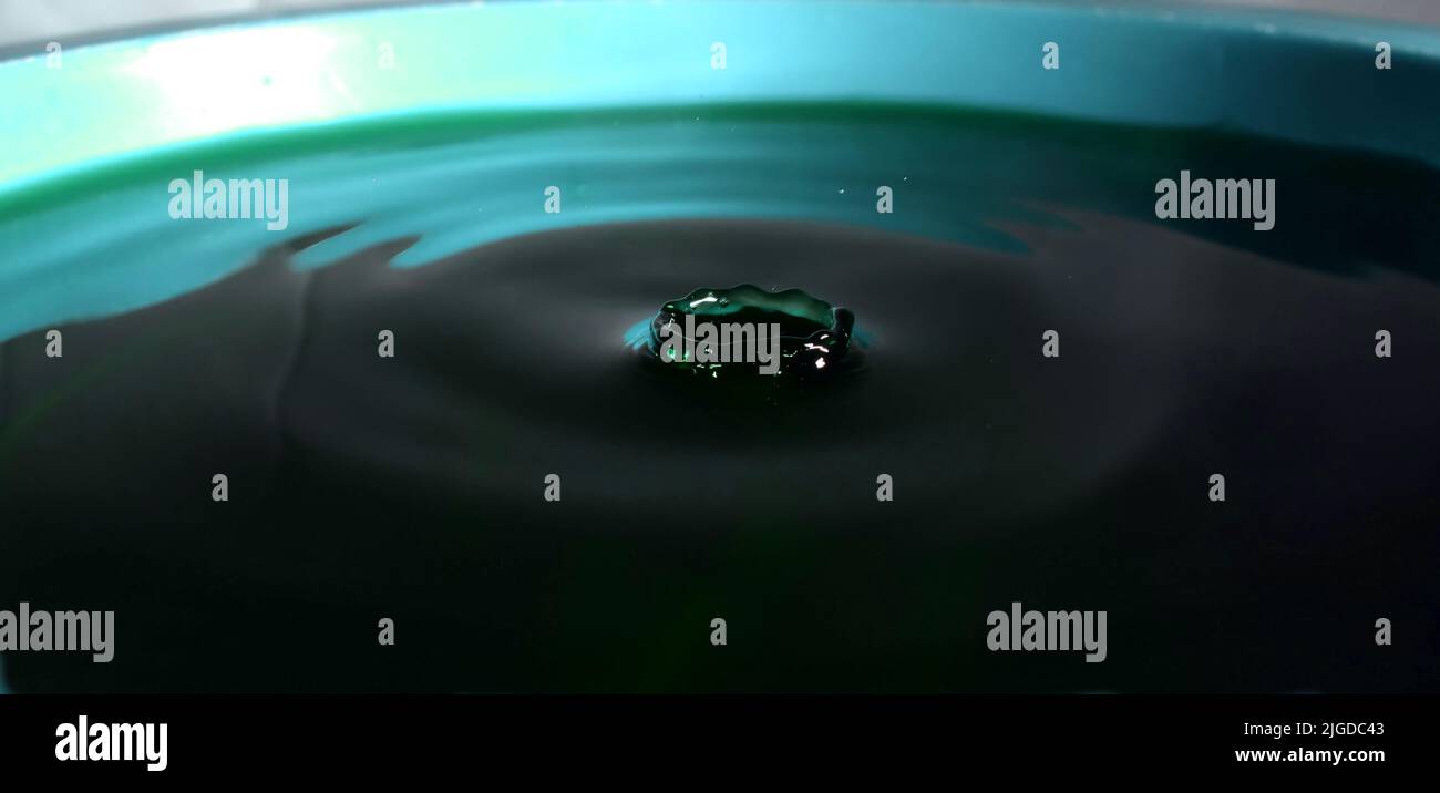 Water Drop Photography: A close up of green water drop crown Stock ...