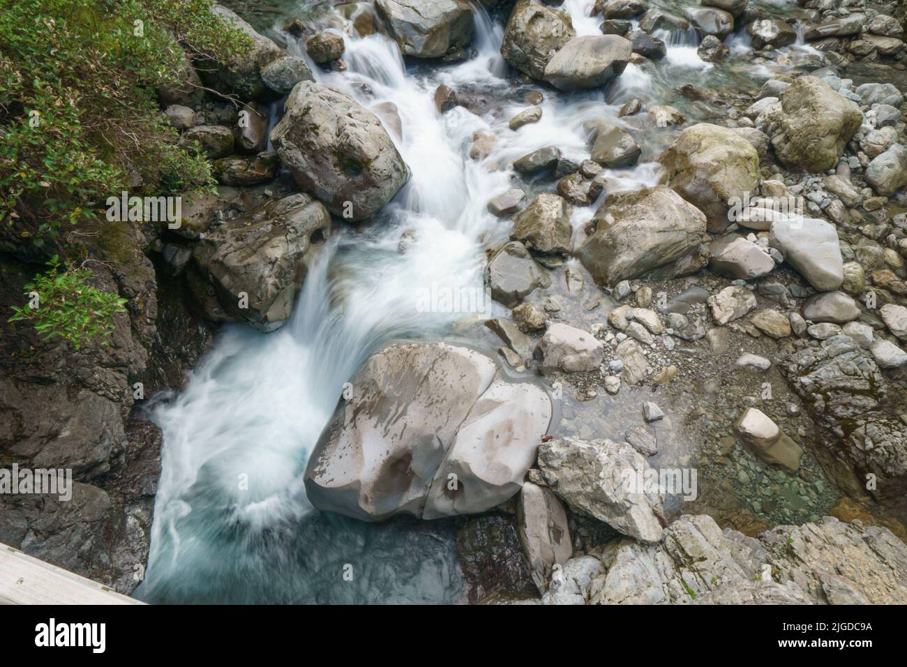 Small waterfall tumbling and splashing down in Bealey river in Southern ...
