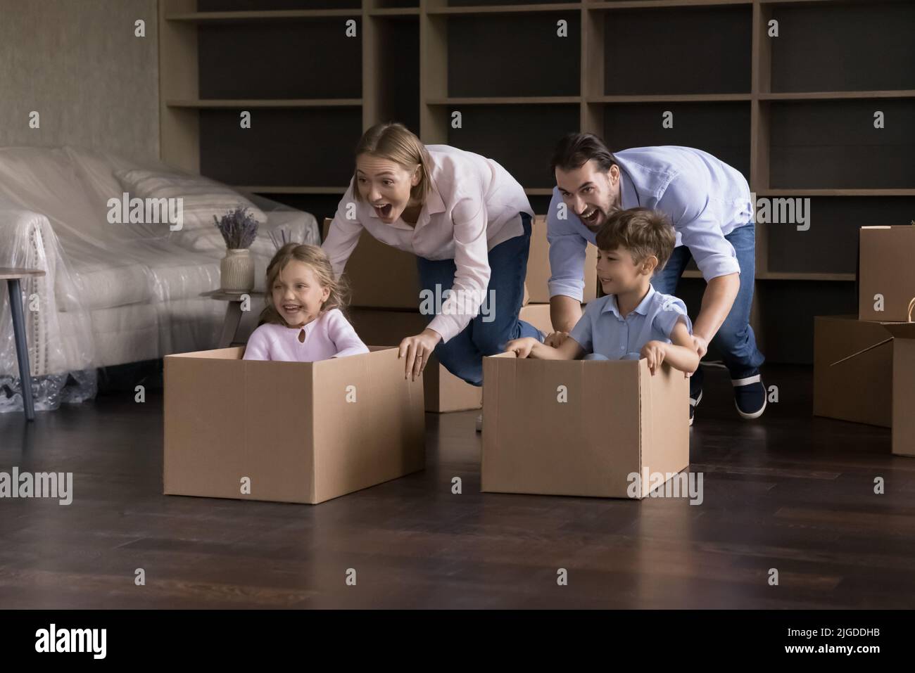 Excited happy parents and kids celebrating moving into new home Stock ...