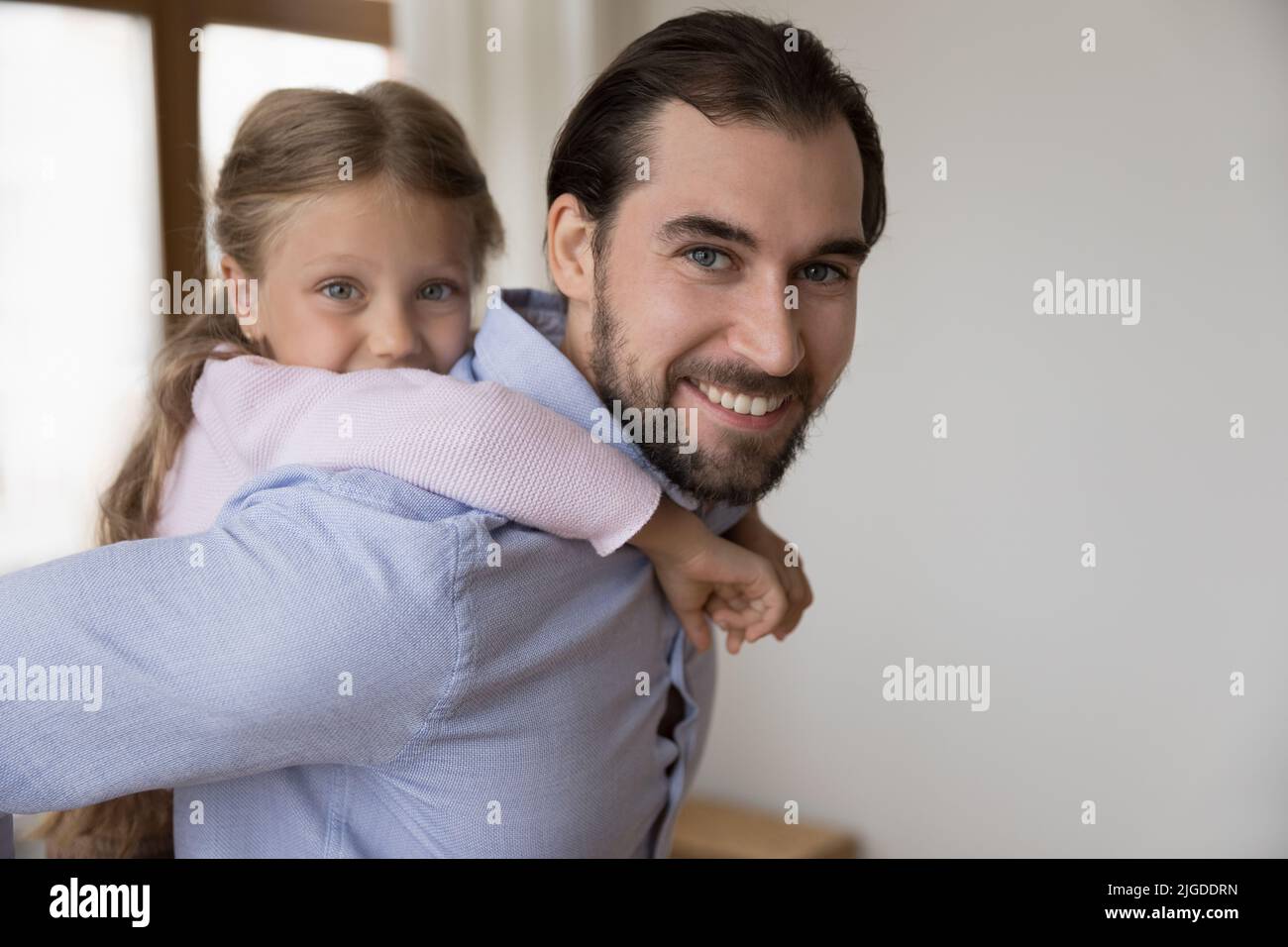 Happy handsome young dad carrying cute little daughter on back Stock ...