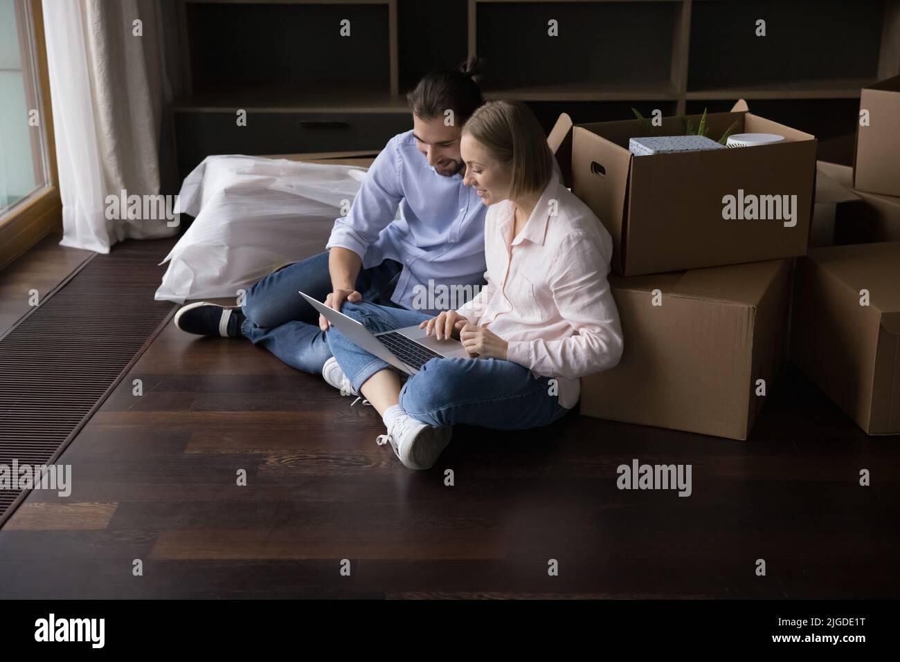 Positive millennial married couple of renters moving into new home ...