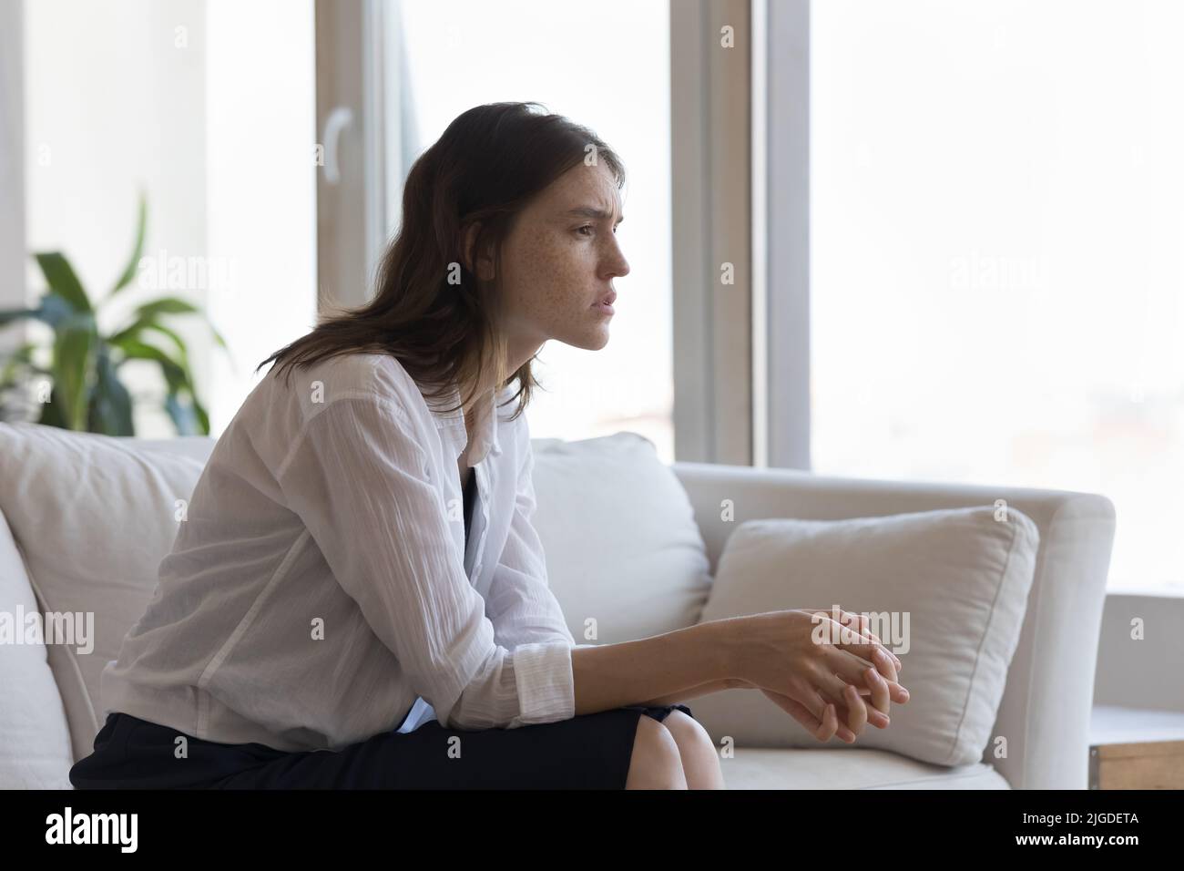 Sad disappointed teen girl sits thinking staring into distance Stock ...