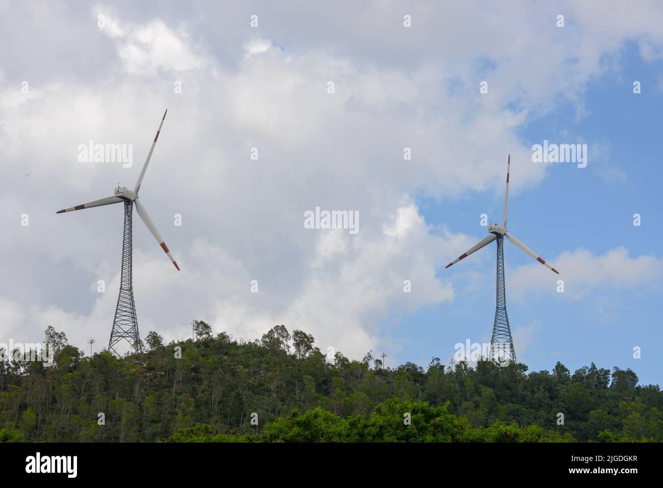 Wind power turbines on towers installed on hills for electricity ...