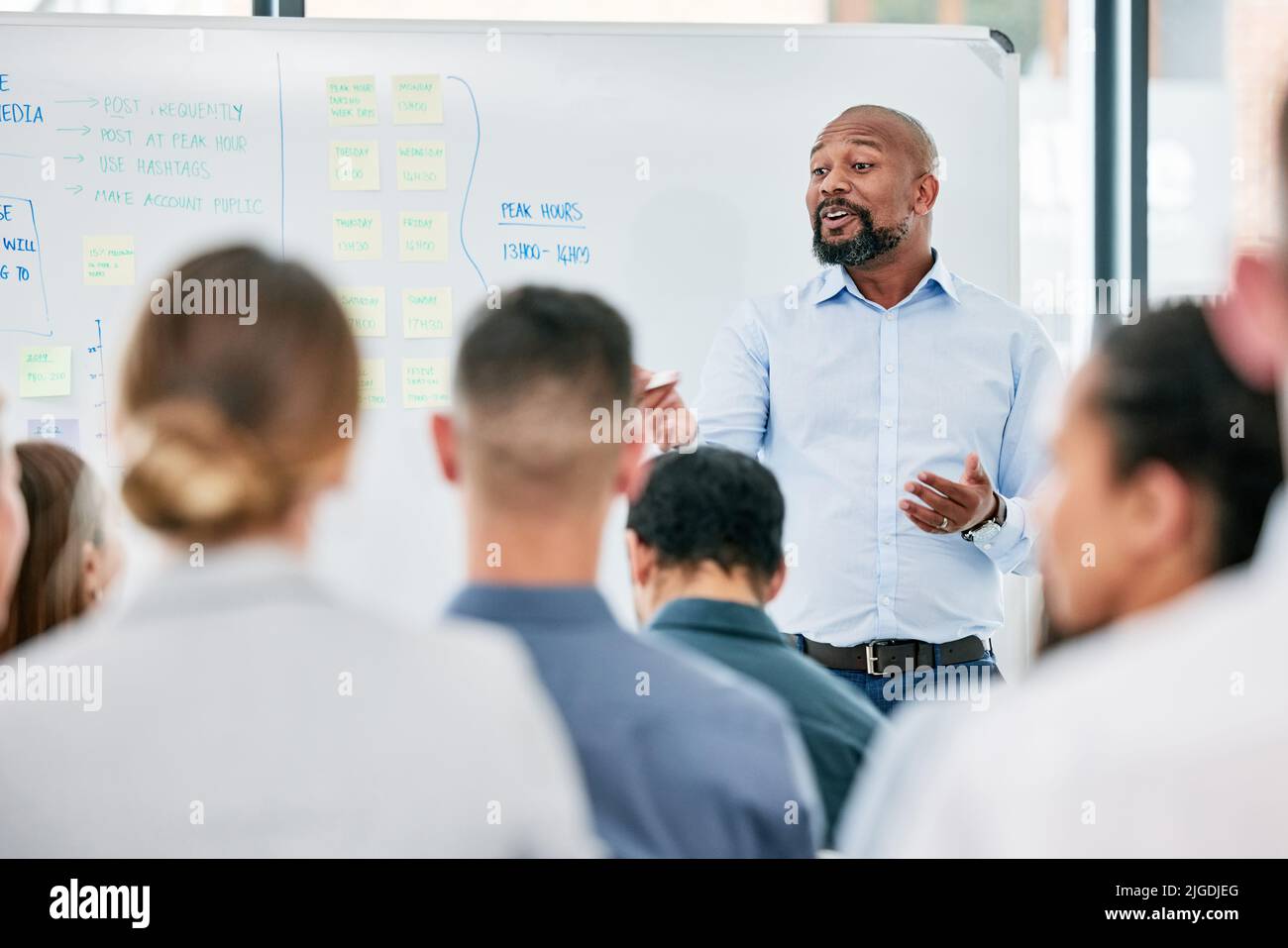Questions. a handsome mature businessman giving a presentation in the ...