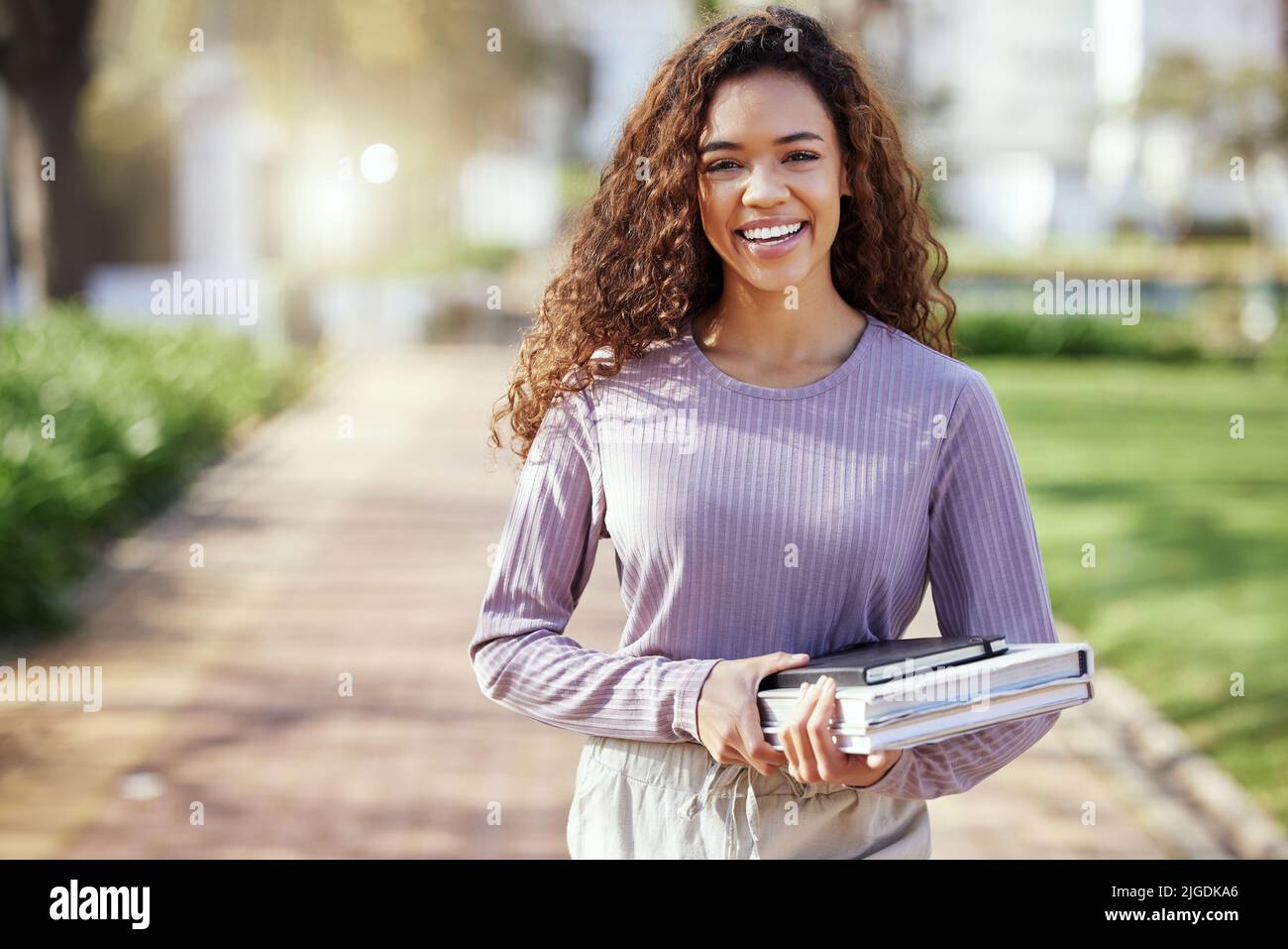 Im ready for class. a young female student studying in nature Stock ...