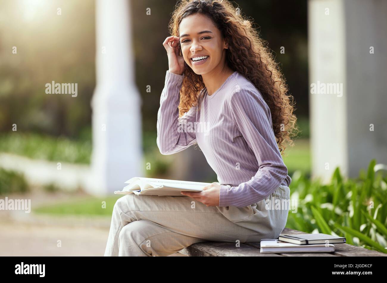 Education is wealth. a young female student studying in nature Stock ...
