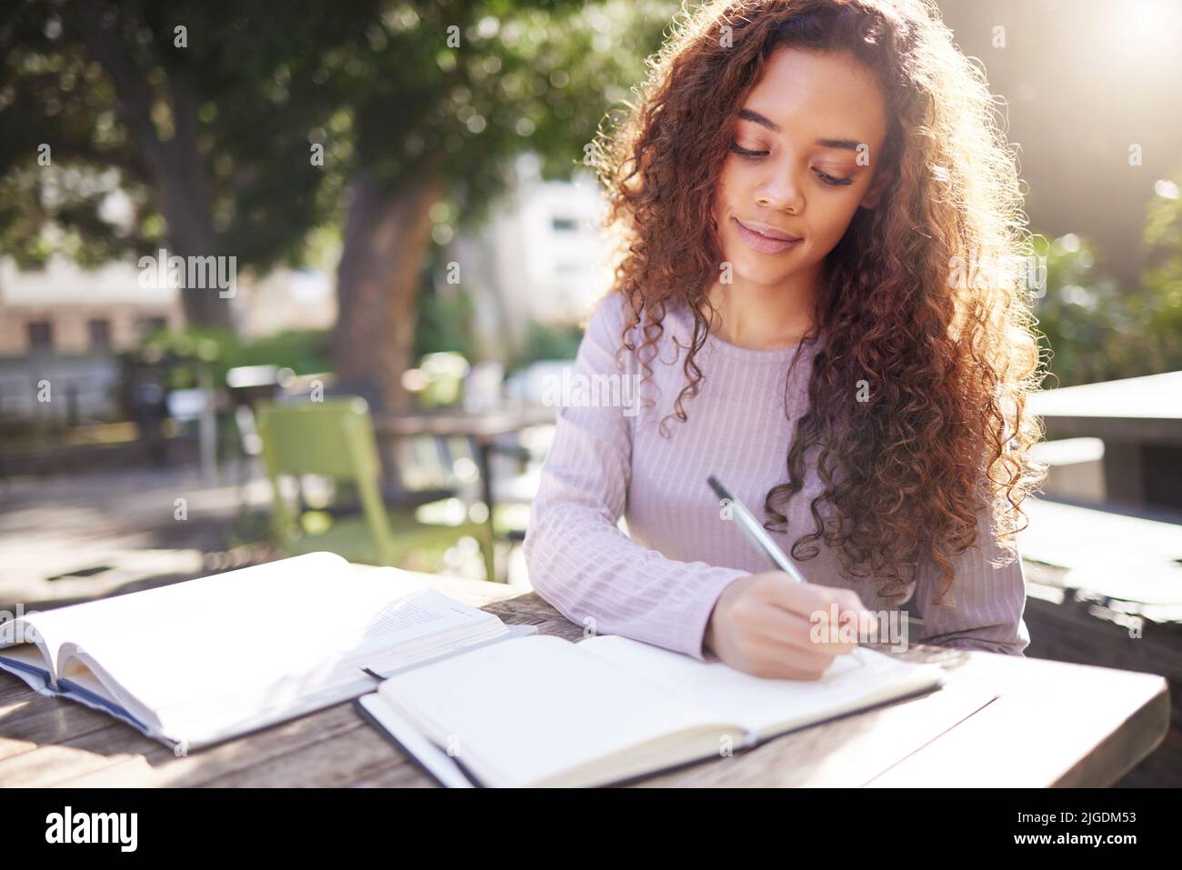 Its exam time. a young female student studying at a cafe Stock Photo ...