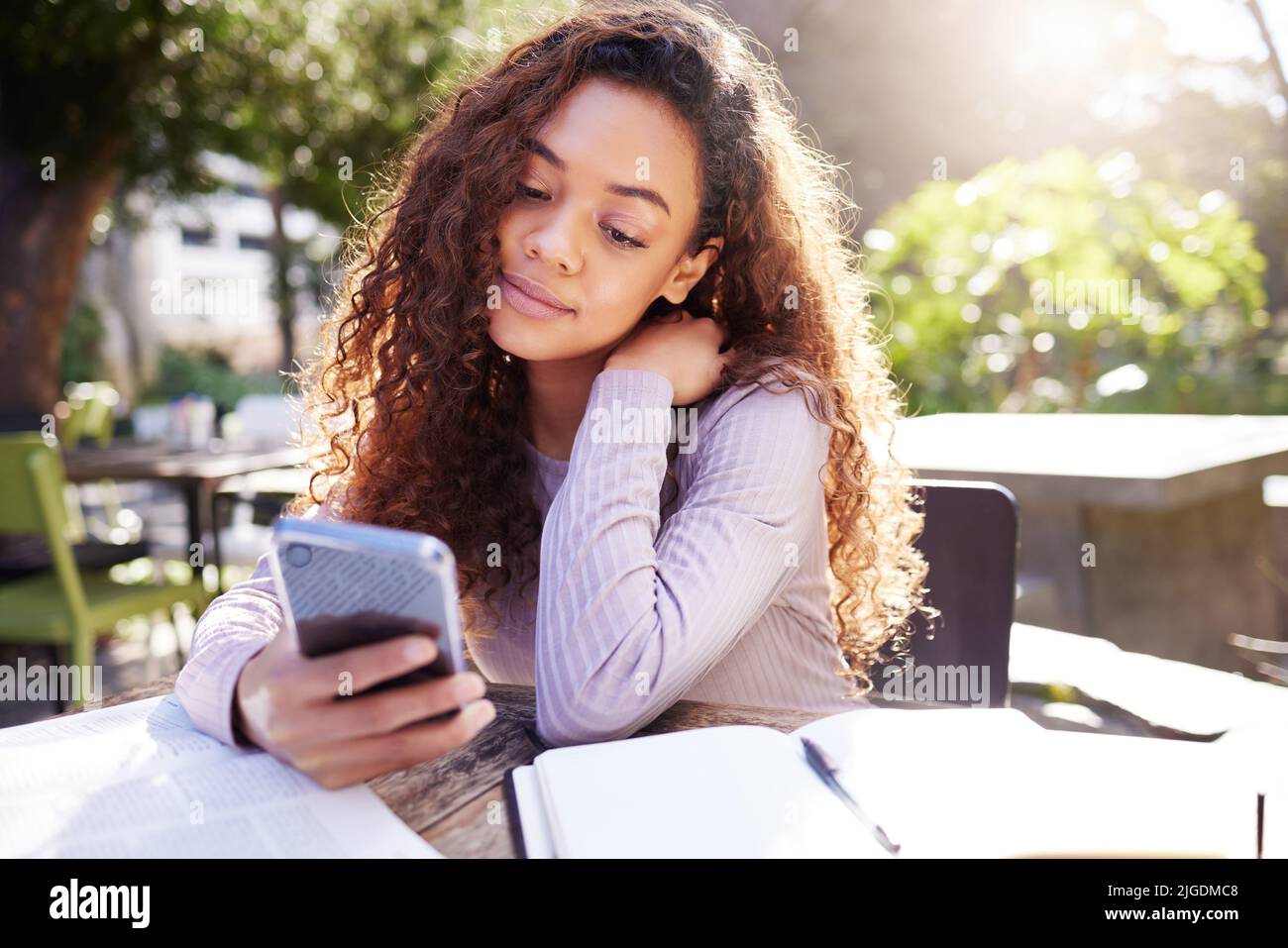 Whats happening on social media. a young female student using a phone ...