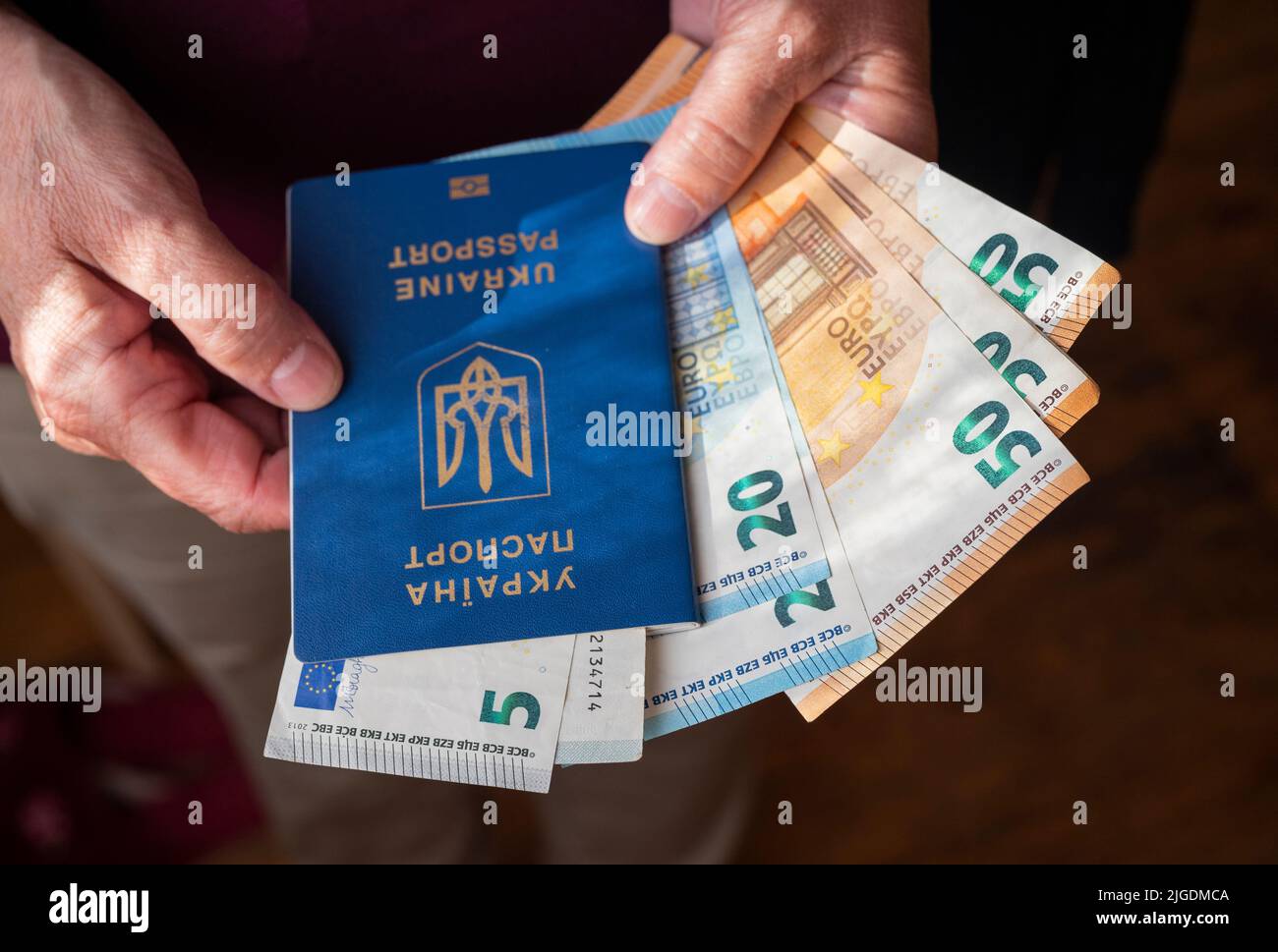 A Woman Pensioner Holds In Her Hands A Ukrainian Biometric Passport