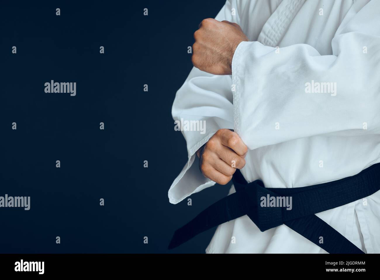 Stand strong. an unrecognizable male martial artist practicing karate ...