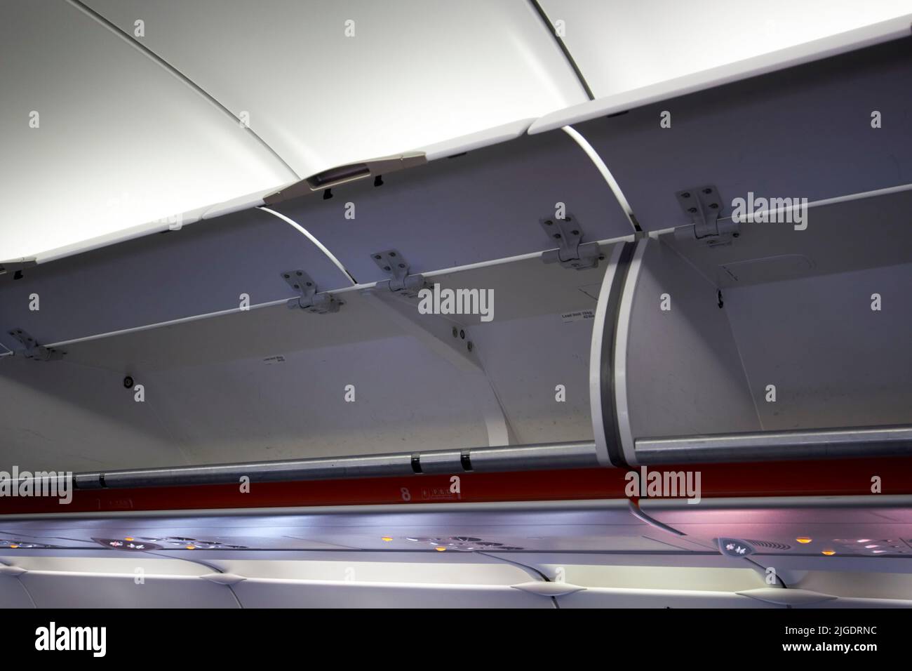 empty overhead lockers on aircraft flight in the uk Stock Photo - Alamy