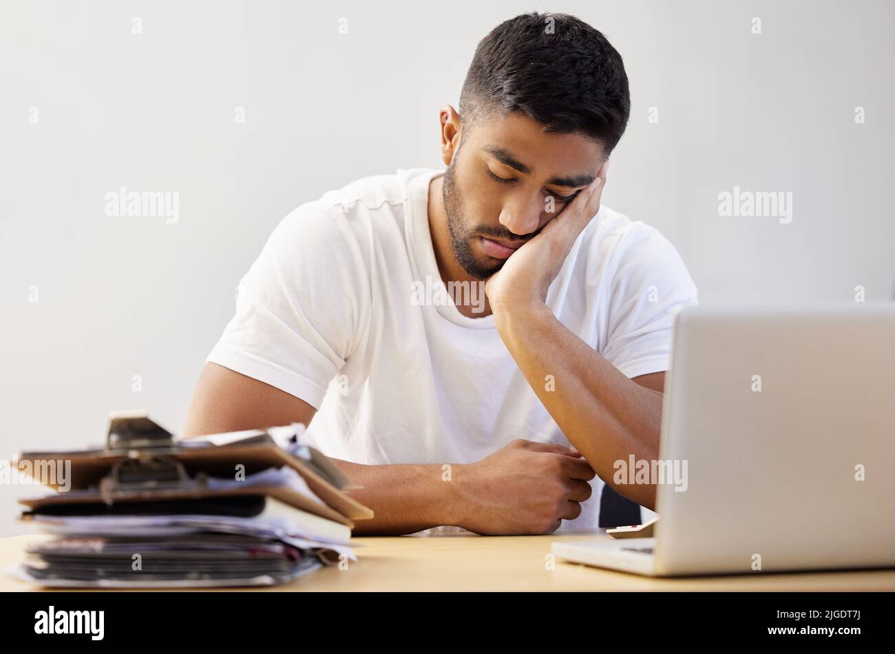 I cant handle boring work. a handsome young man sitting alone and ...